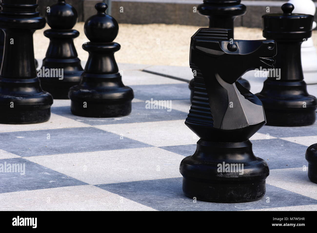 Chess pieces on an outside chess board Stock Photo - Alamy