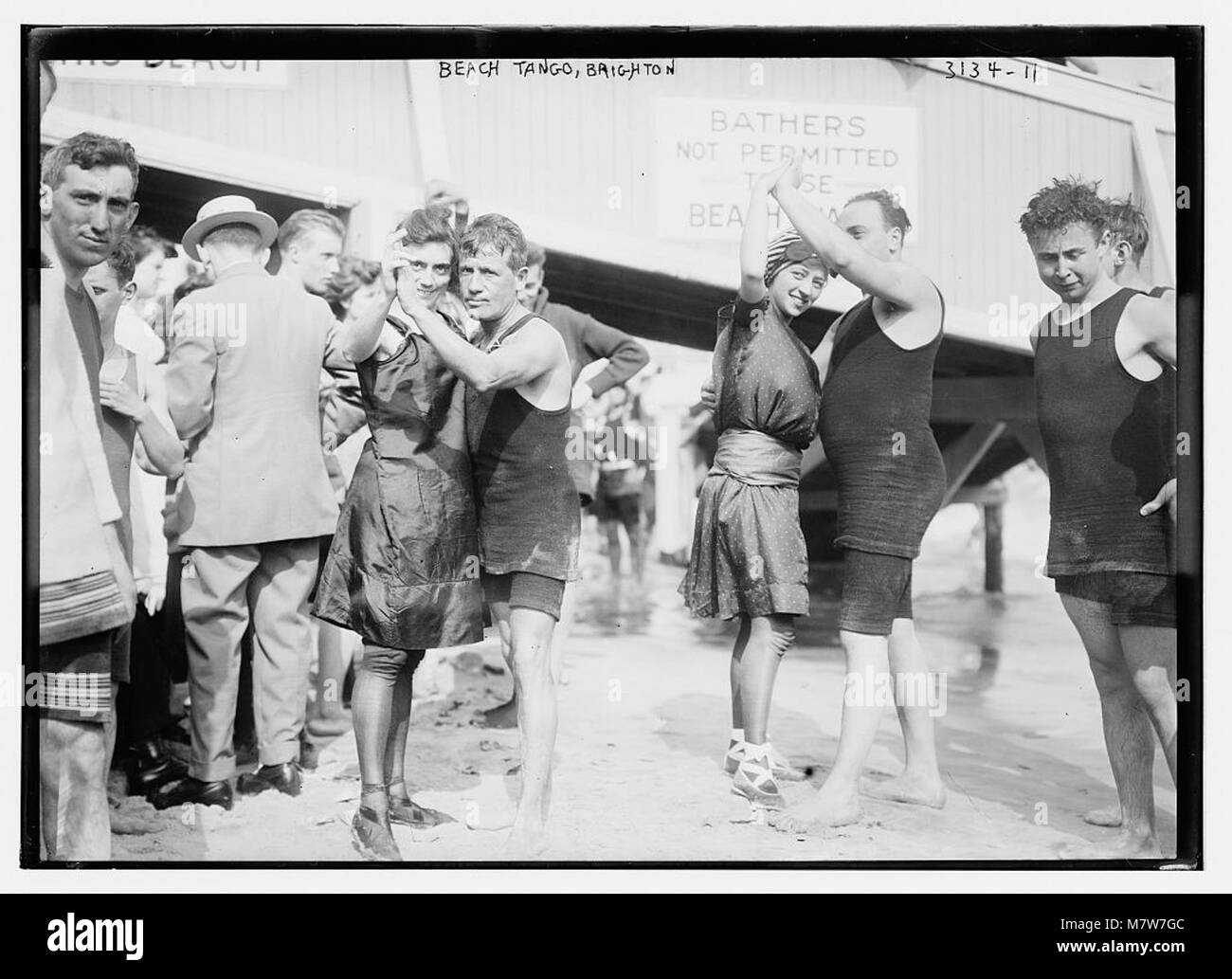 This photograph shows a lively scene of a beach tango dance performance ...