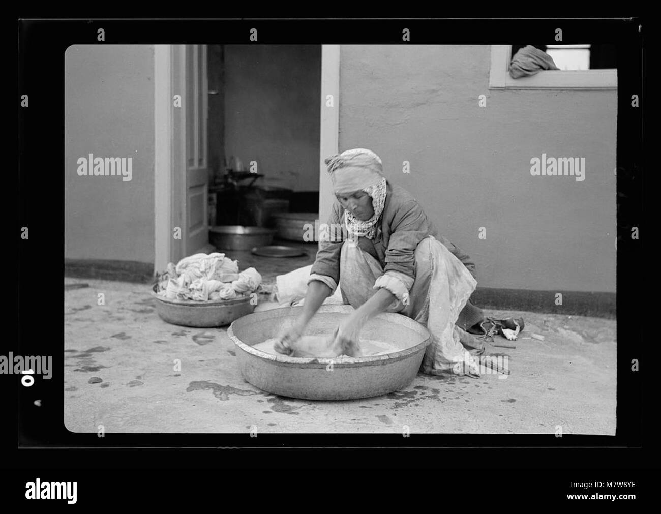 A photograph depicting a Bukharan Jewish washerwoman in her traditional ...