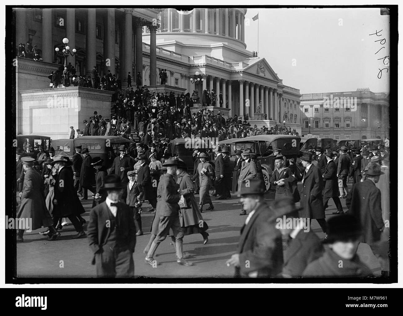 A photograph of the U.S. Capitol building with a crowd of visitors ...