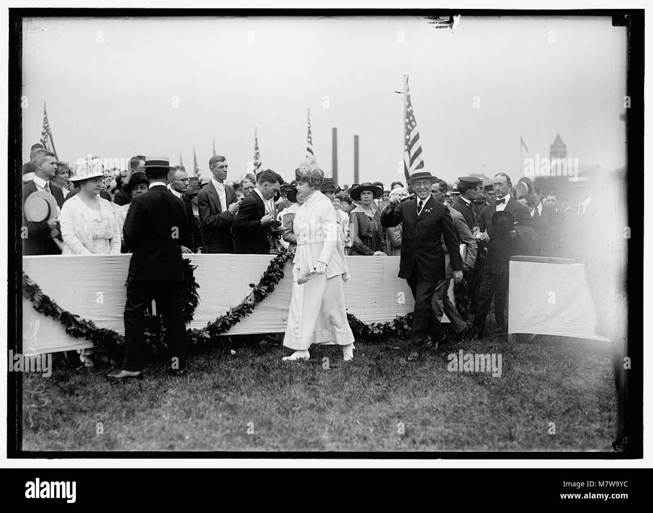 Flag Day ceremonies take place at a monument, with a large crowd ...