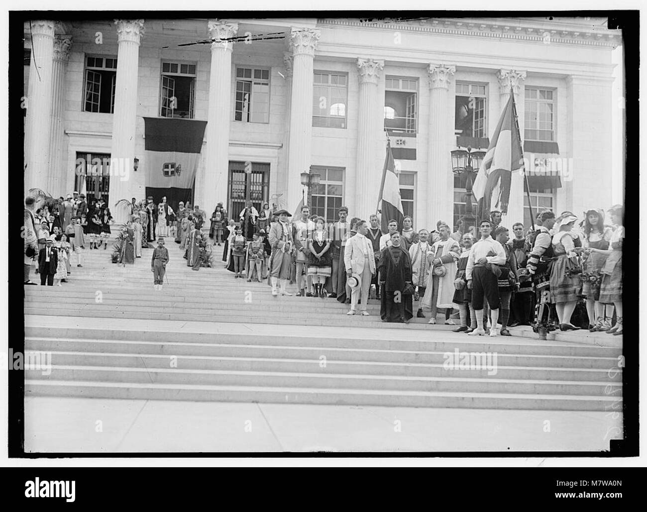The image shows foreign groups gathered on the steps of the Red Cross ...