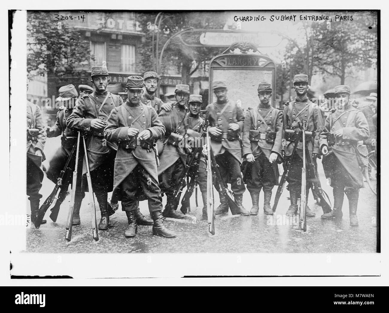 A historic image showing guards stationed at the entrance of a subway ...