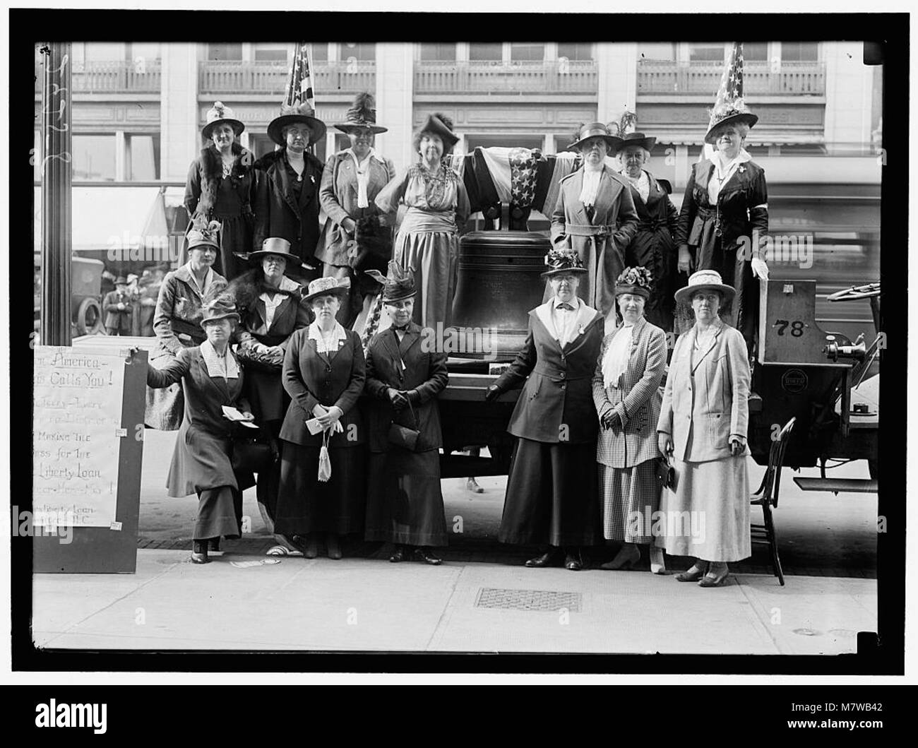 A photograph showing a replica of the Liberty Bell with members of the ...