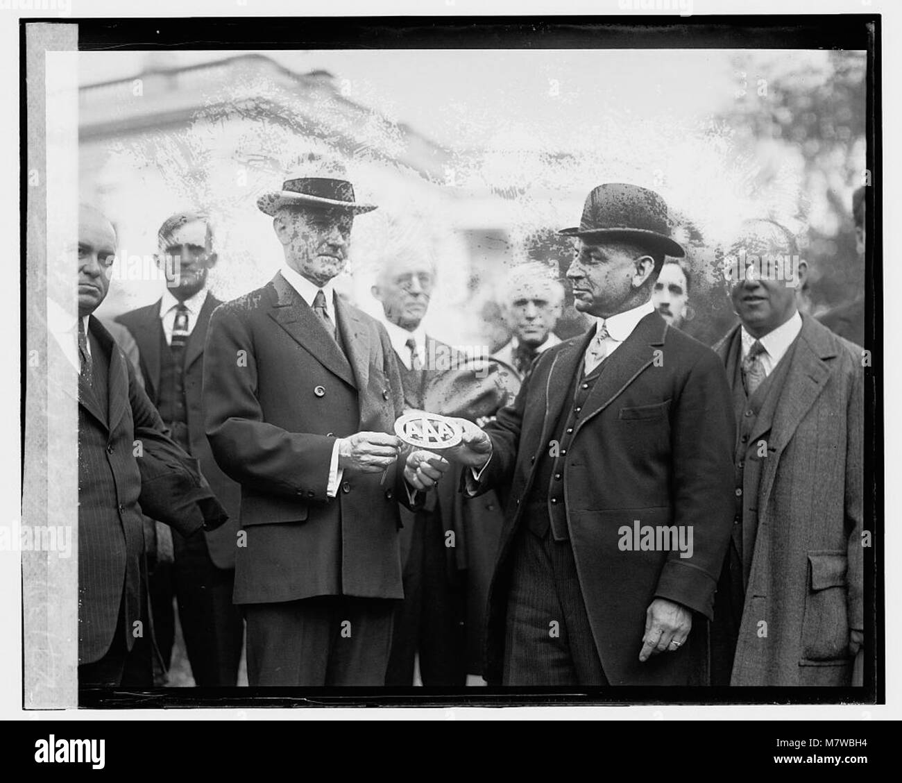 This photograph shows Calvin Coolidge alongside the American Automobile ...