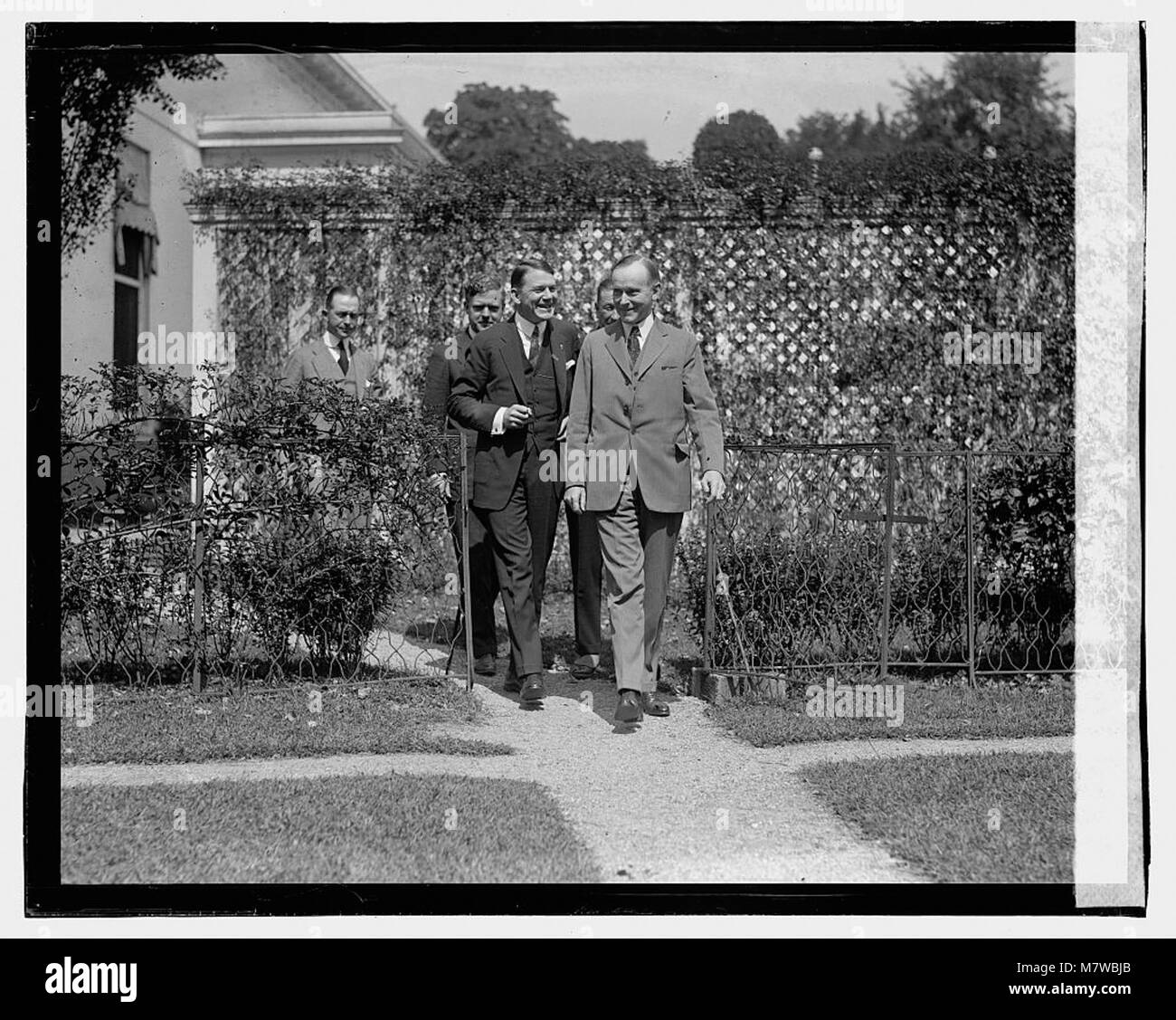 A photograph featuring President Calvin Coolidge alongside members of ...