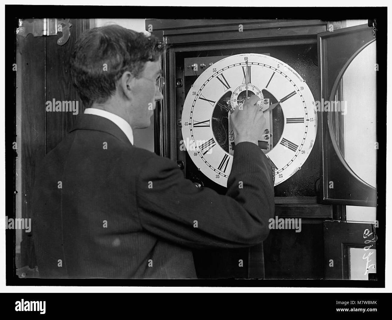 The image depicts C.B. Watts at the Naval Observatory, resetting or ...