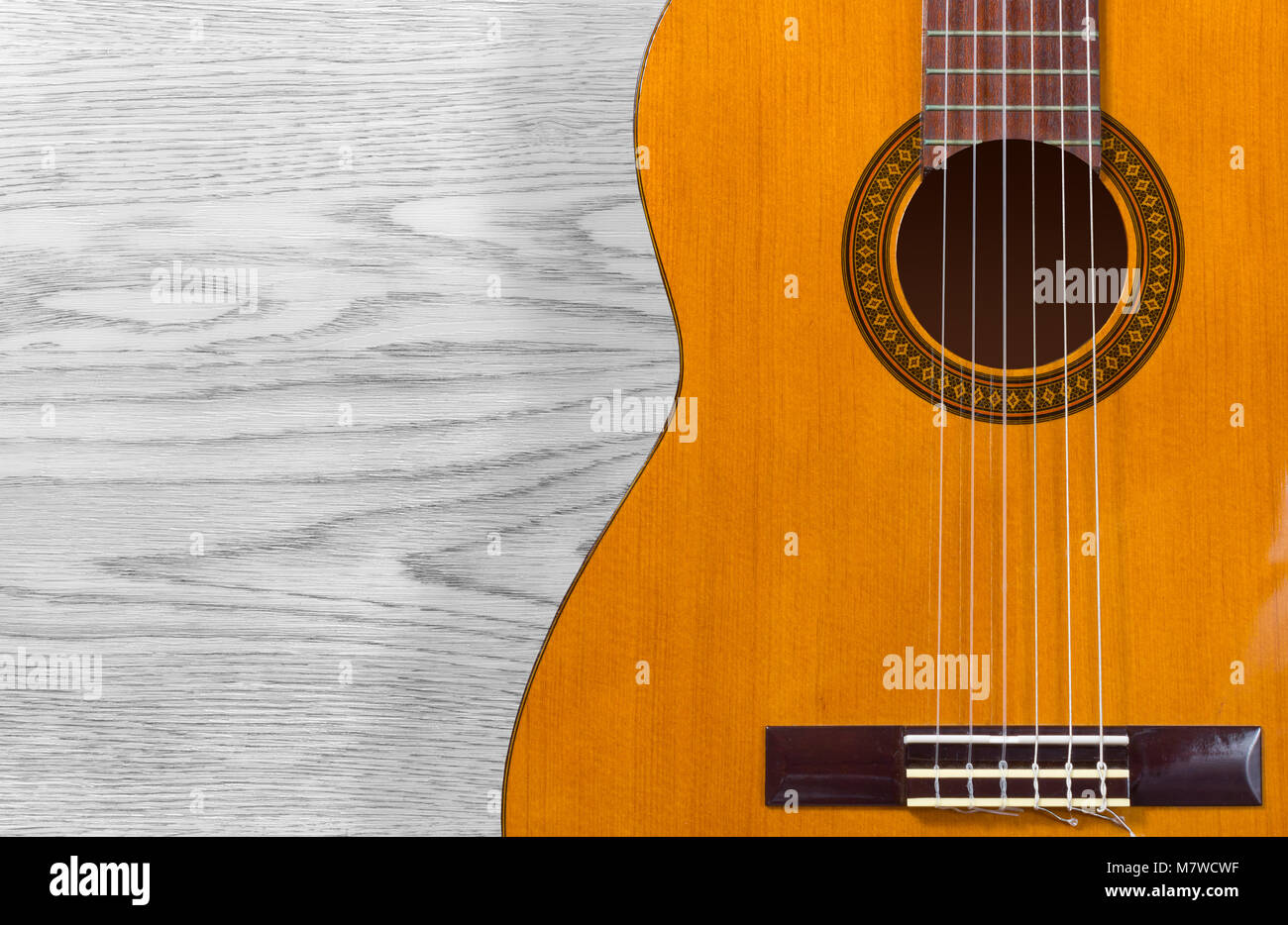 Classical guitar over a white wood texture background Stock Photo - Alamy