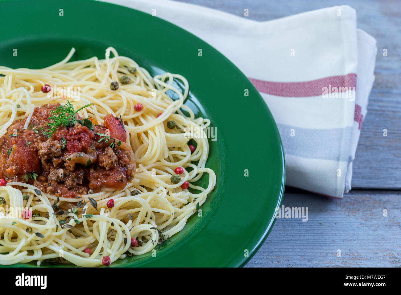 Green plate of Traditional Italian spahgetti Bolognaise or Bolognese ...