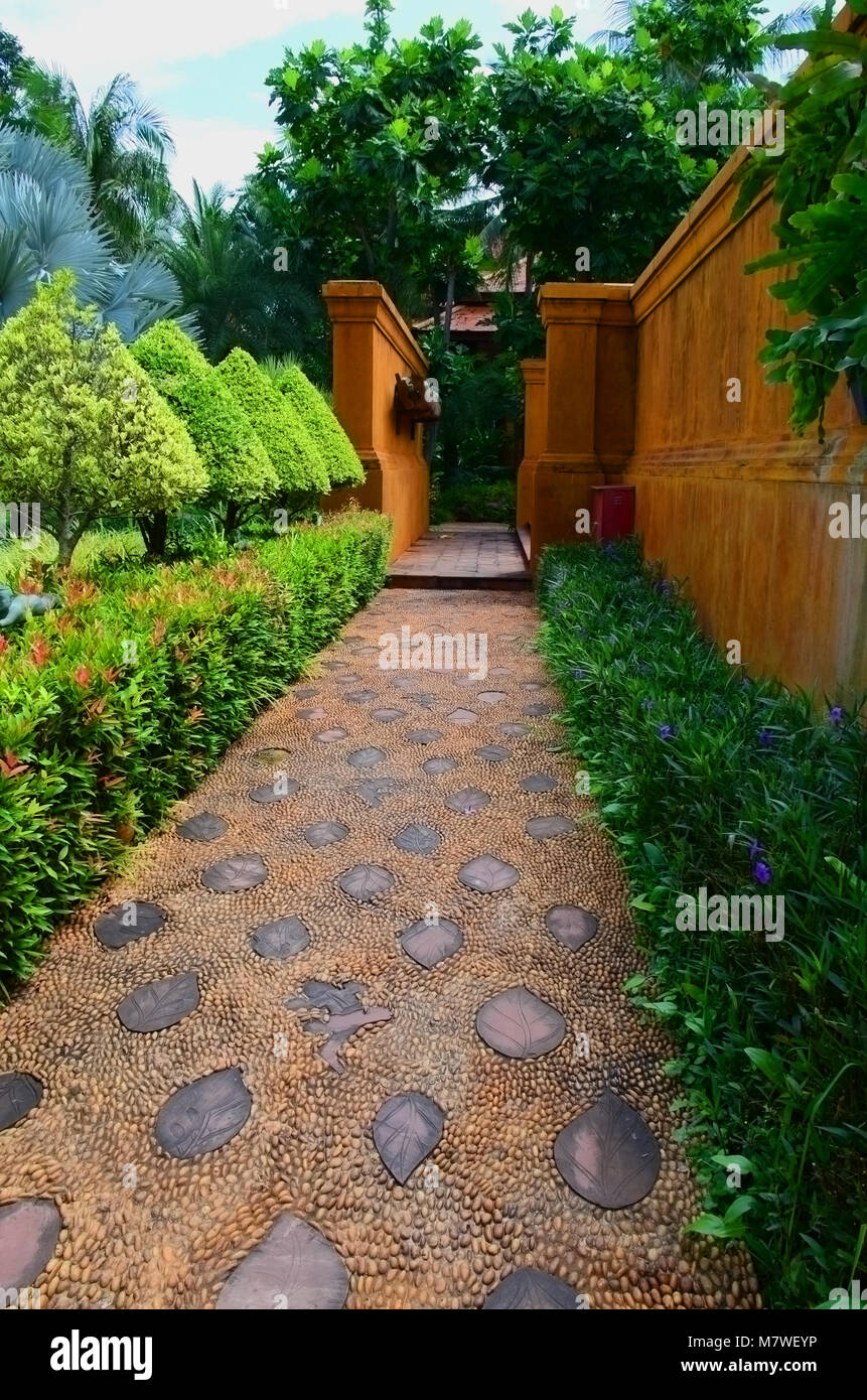 A pathway made from cobblestones, interspersed with manufactured paving ...
