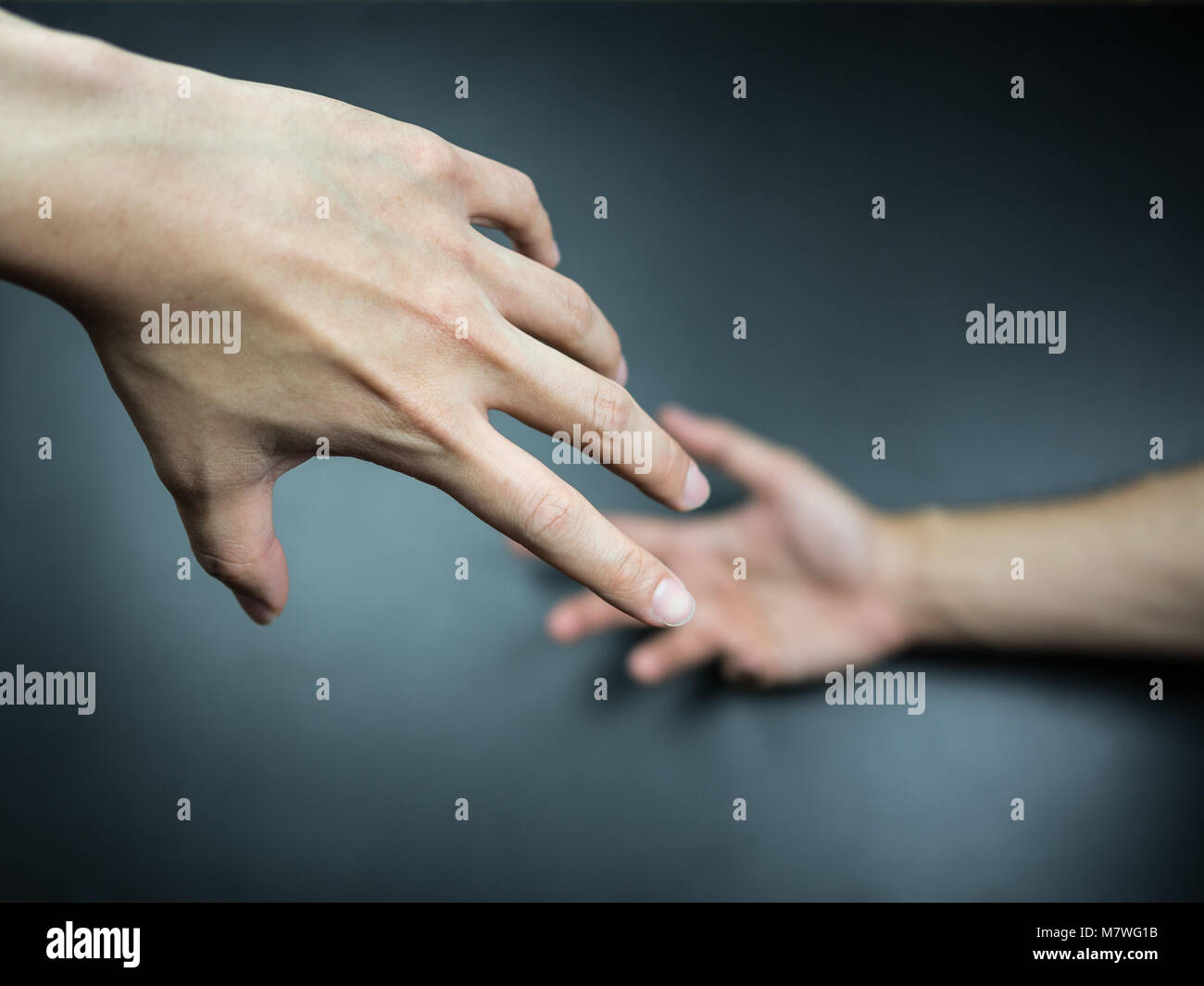Hands reaching for each other hi-res stock photography and images - Alamy