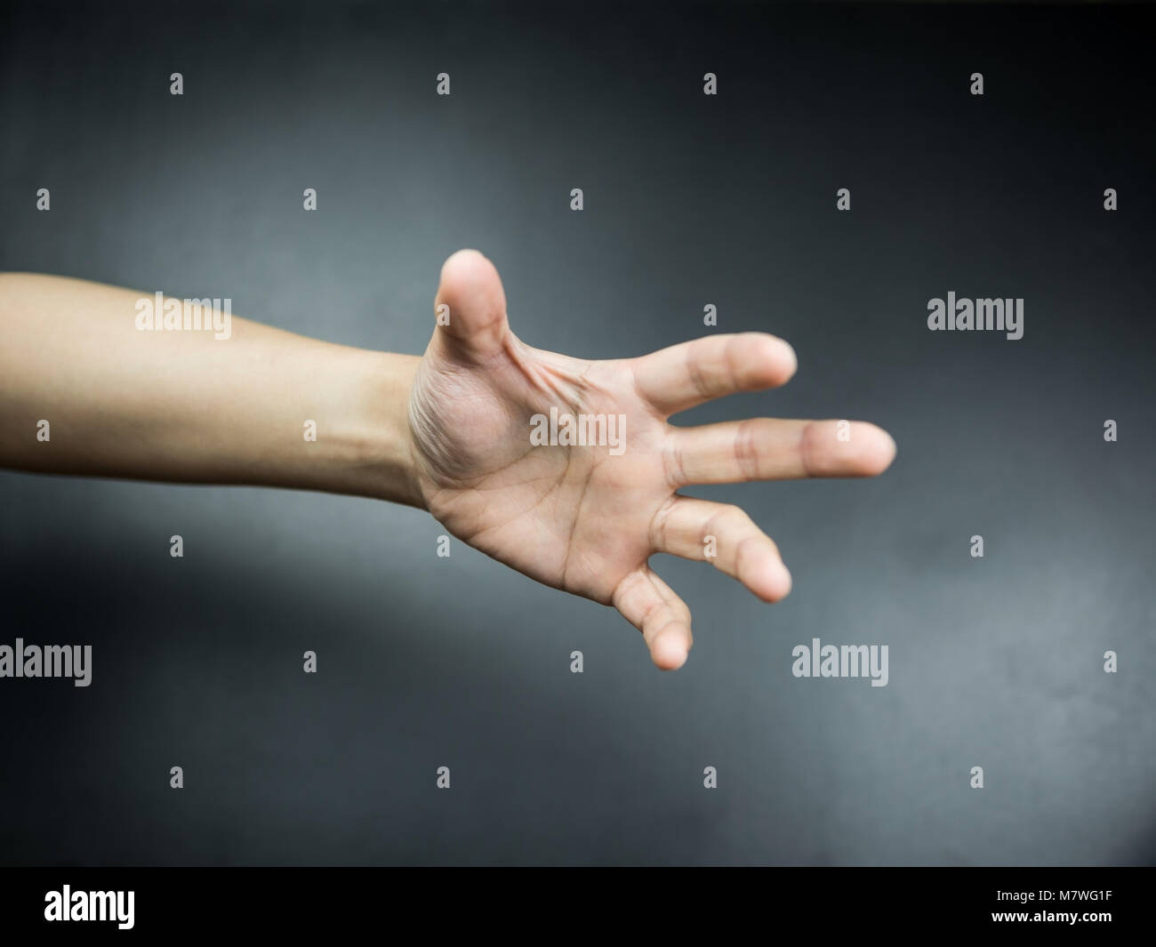 Hand catching toward on black background Stock Photo - Alamy