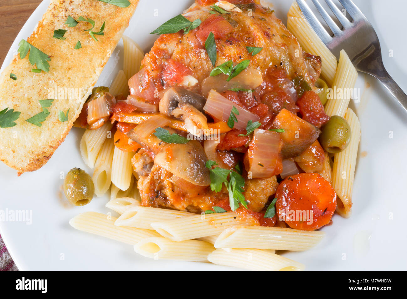 A portion of Italian style Chicken Cacciatore served with penne pasta ...