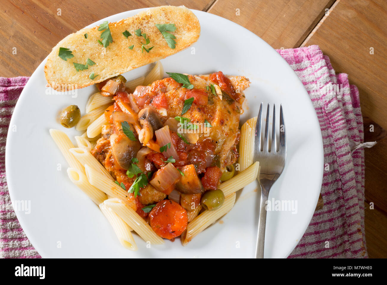 A portion of Italian style Chicken Cacciatore served with penne pasta ...