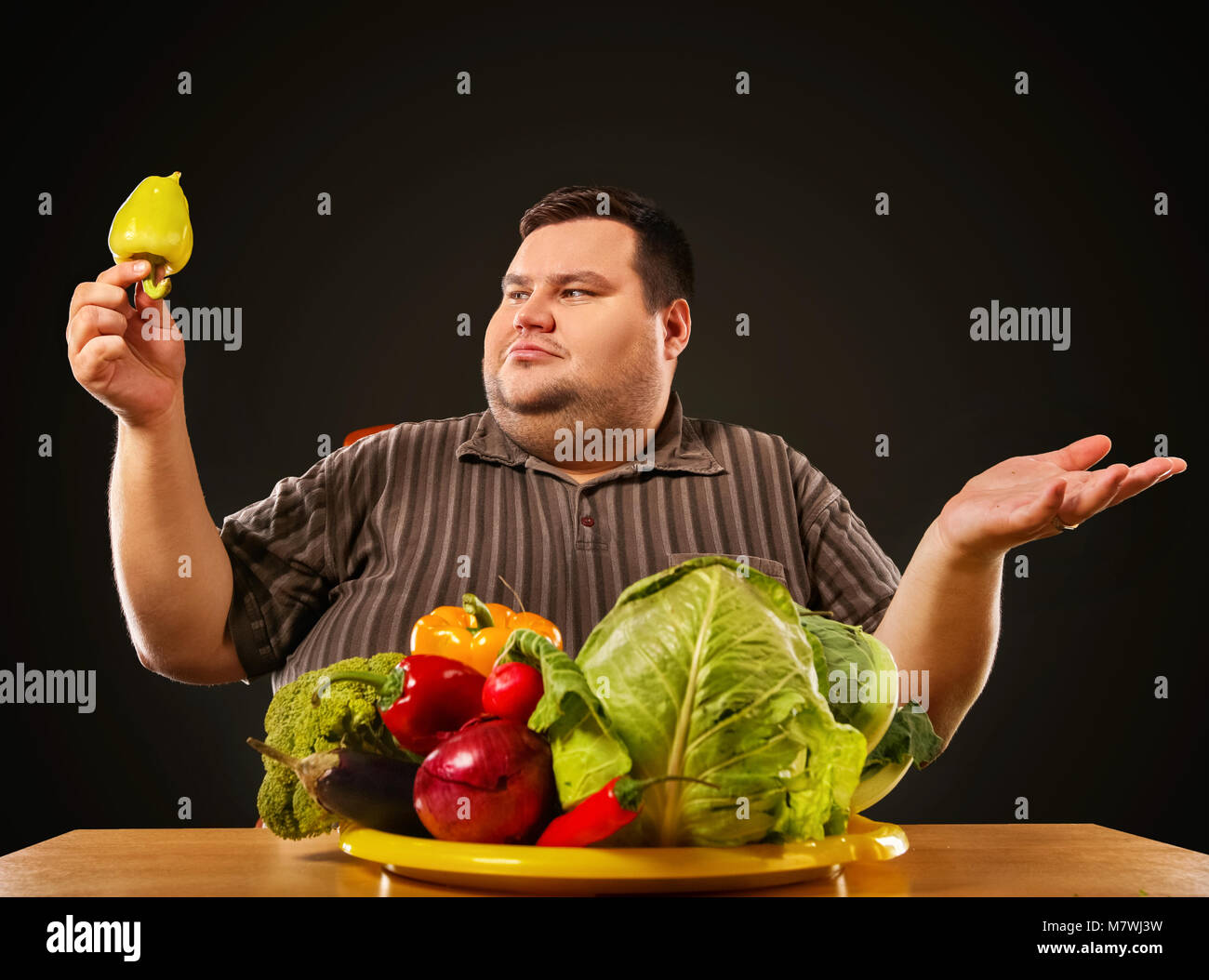 Diet fat man eating healthy food . Healthy breakfast with vegetables ...