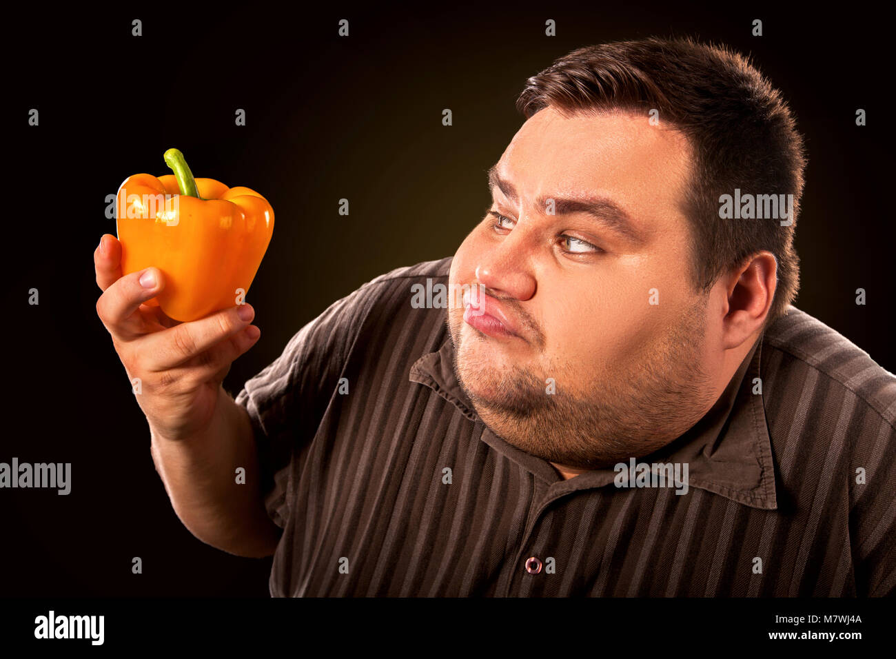 Diet fat man eating healthy food . Healthy breakfast with vegetables ...