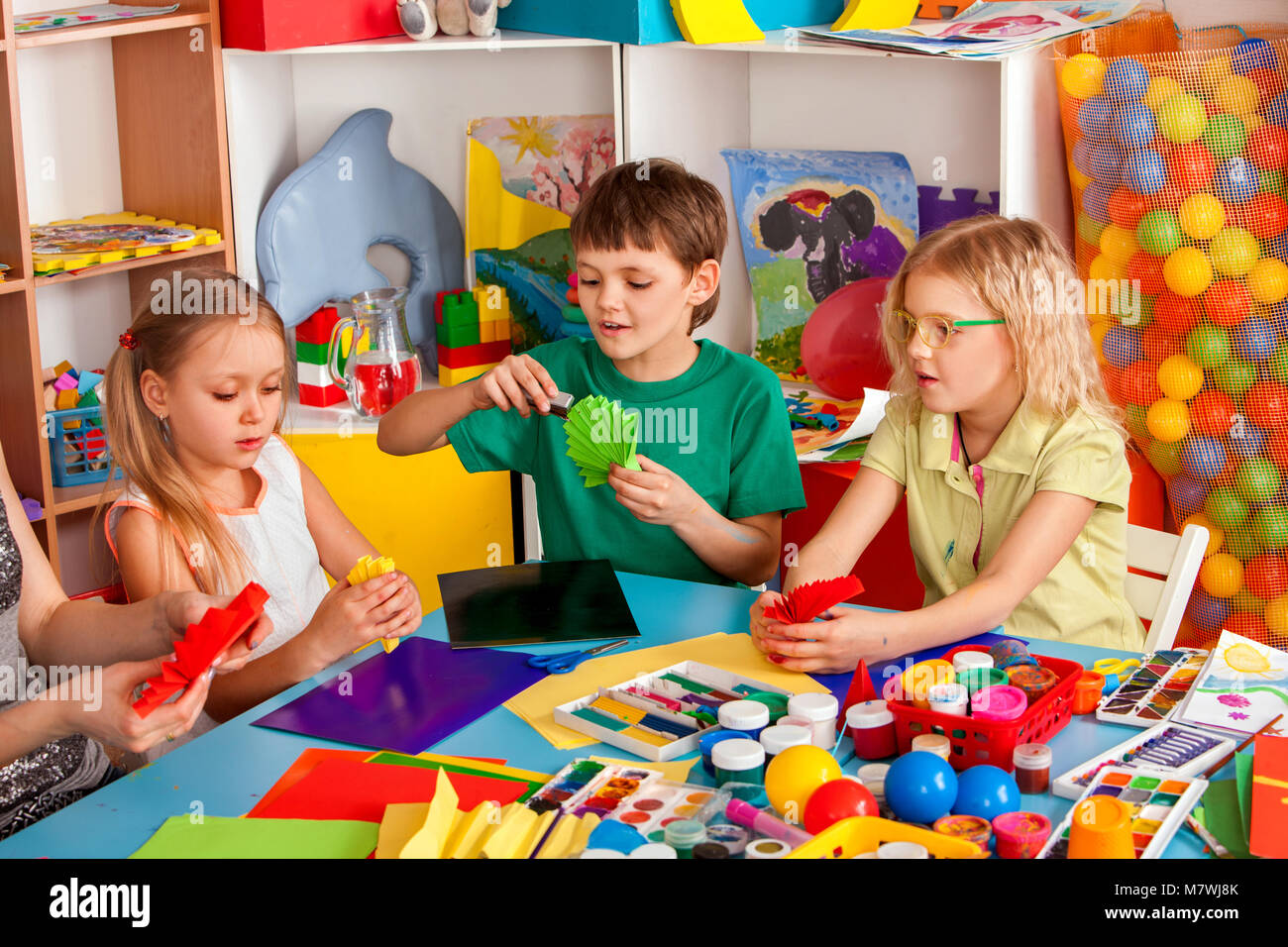 School children with scissors in kids hands cutting paper Stock Photo ...