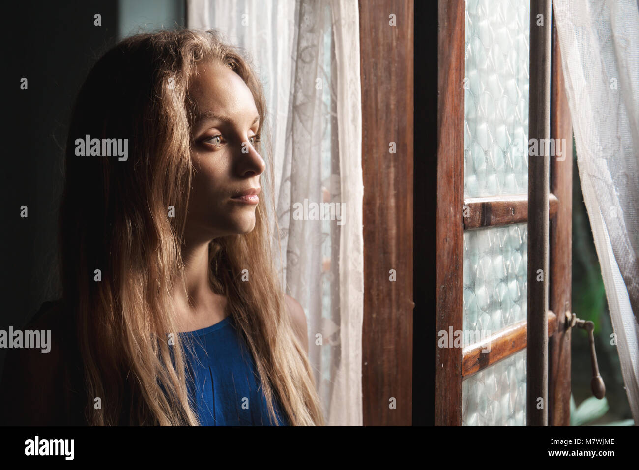 woman near a window Stock Photo - Alamy
