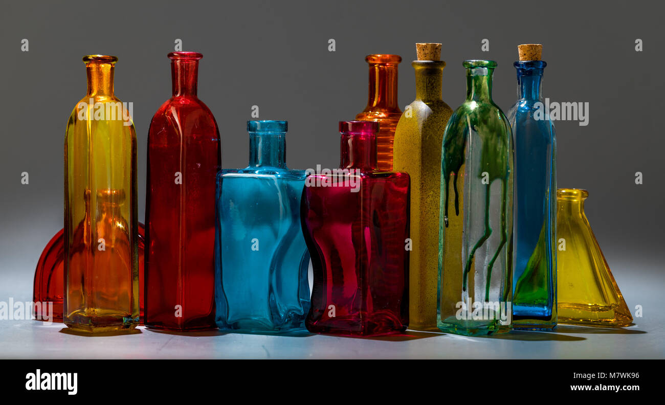 Row of vintage multicolored bottles from glass Stock Photo - Alamy