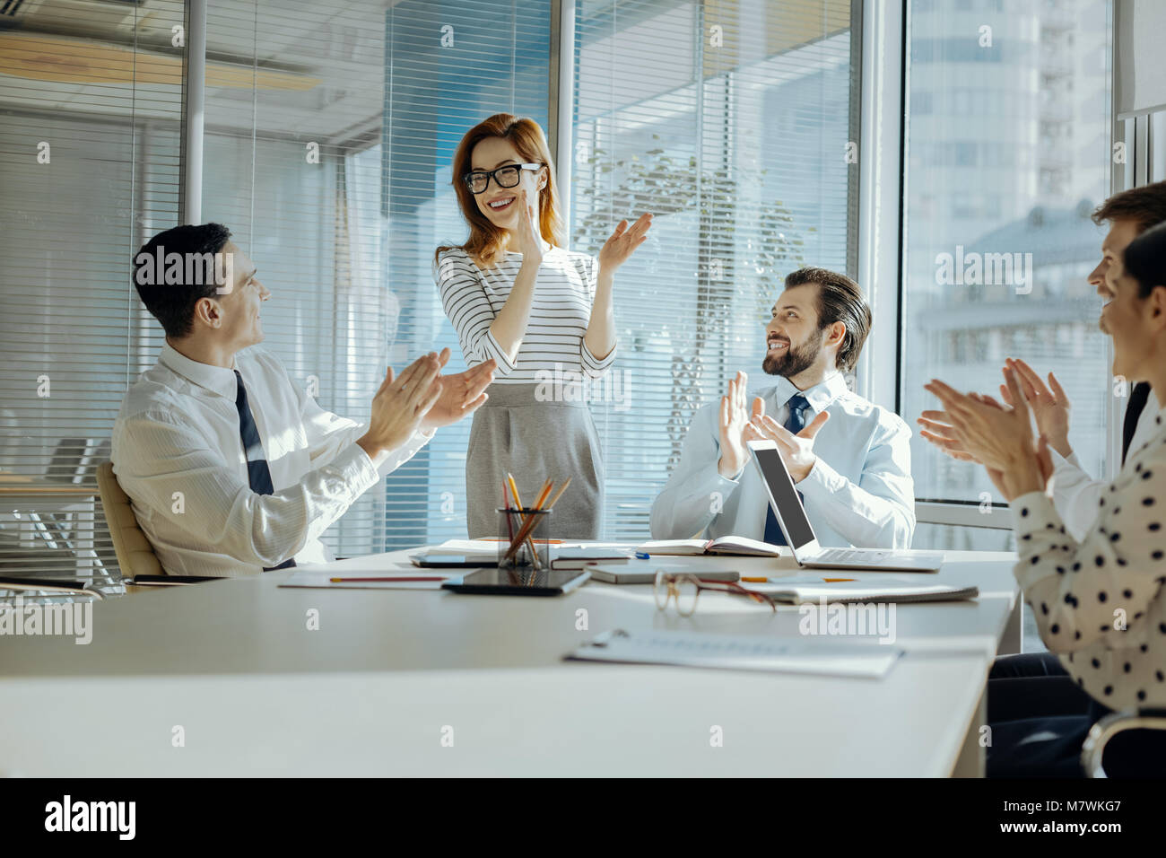 Cheerful colleagues celebrating successful end of project Stock Photo ...