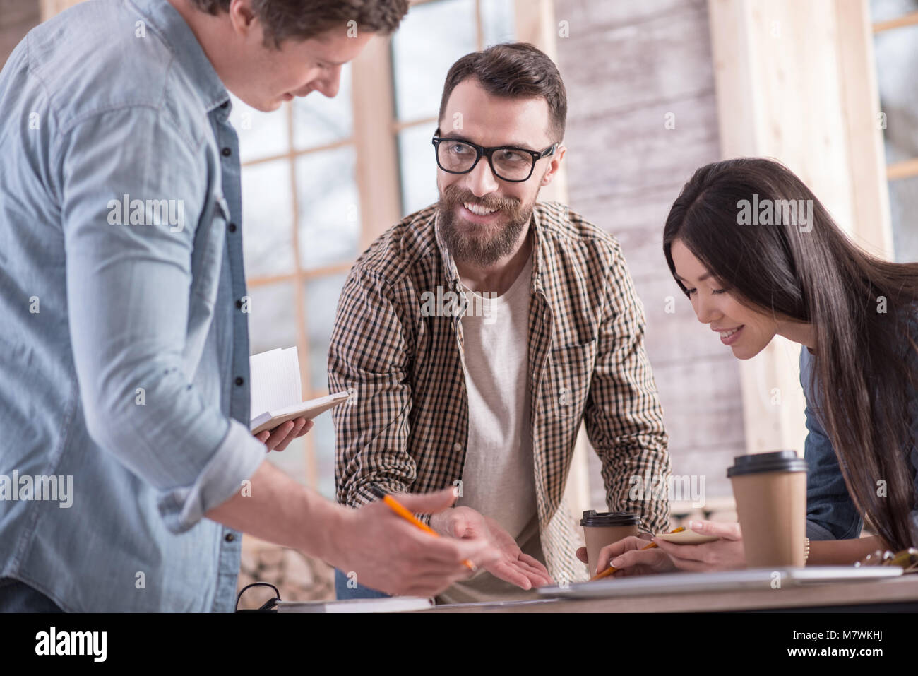 Happy nice students working in team Stock Photo - Alamy
