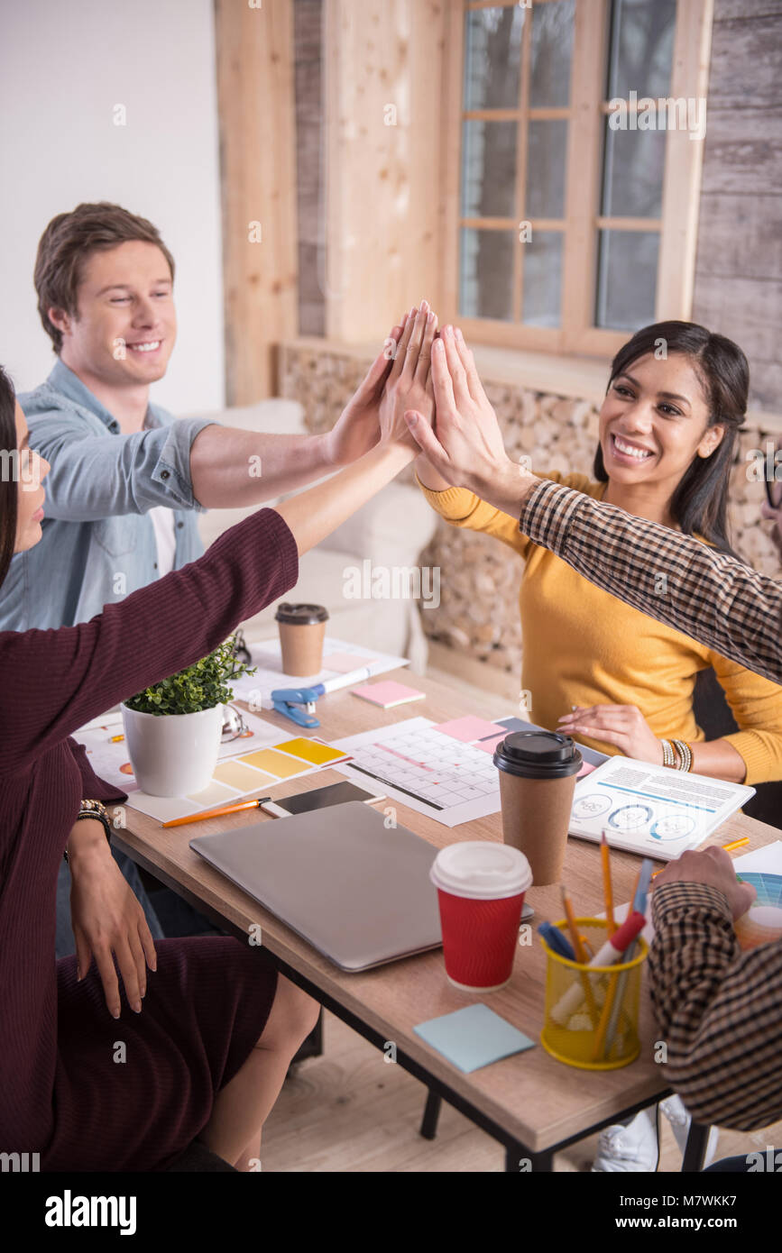 Nice delighted people showing their team spirit Stock Photo - Alamy