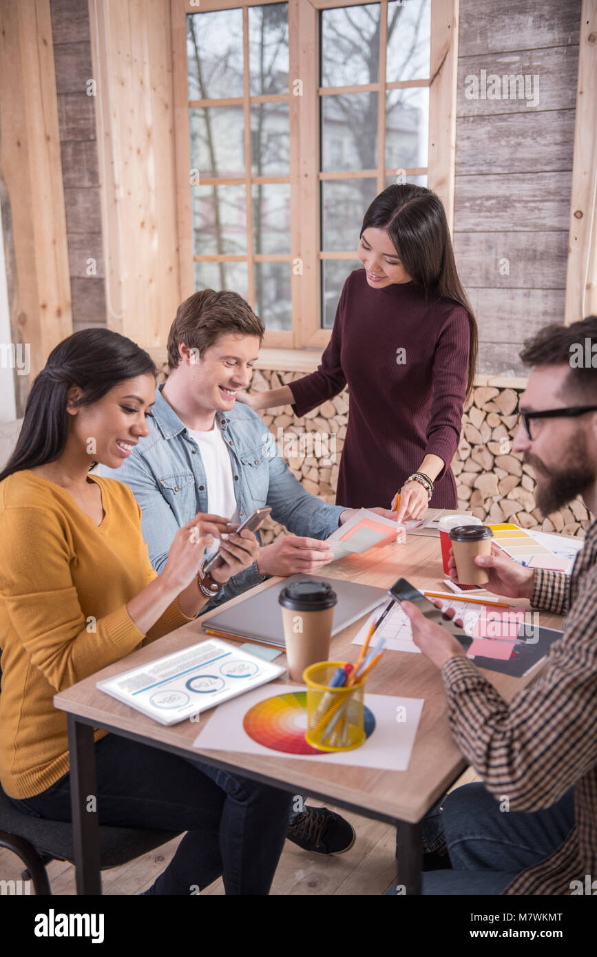 Joyful nice people sitting together Stock Photo - Alamy