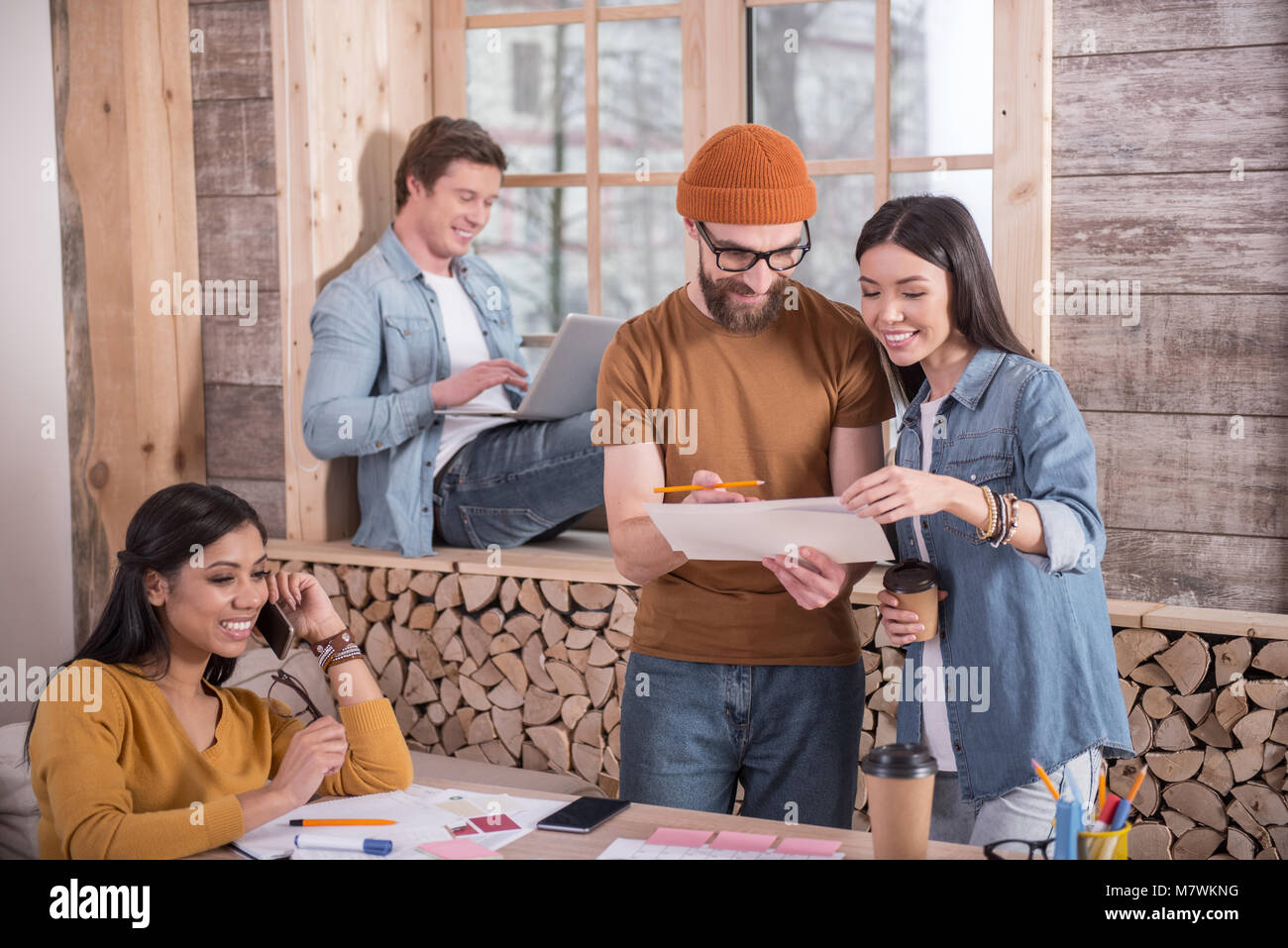 Joyful positive colleagues standing together Stock Photo - Alamy