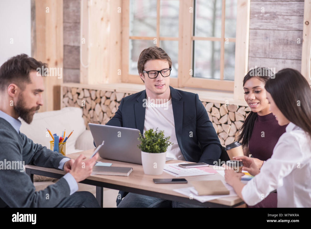 Serious smart man sitting at the table Stock Photo - Alamy