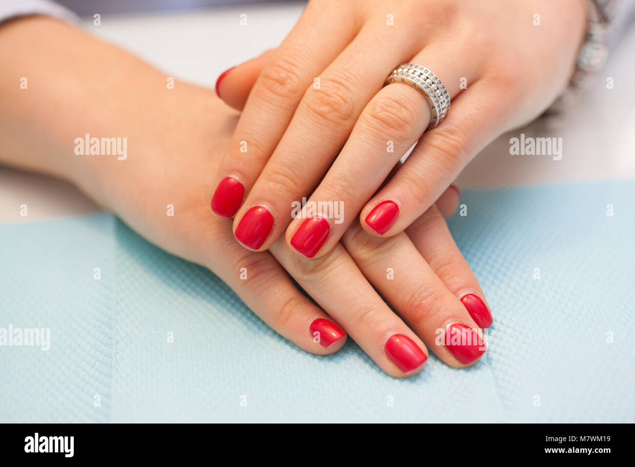 Female nails with red shellac on the table in beauty salon. Beauty and ...