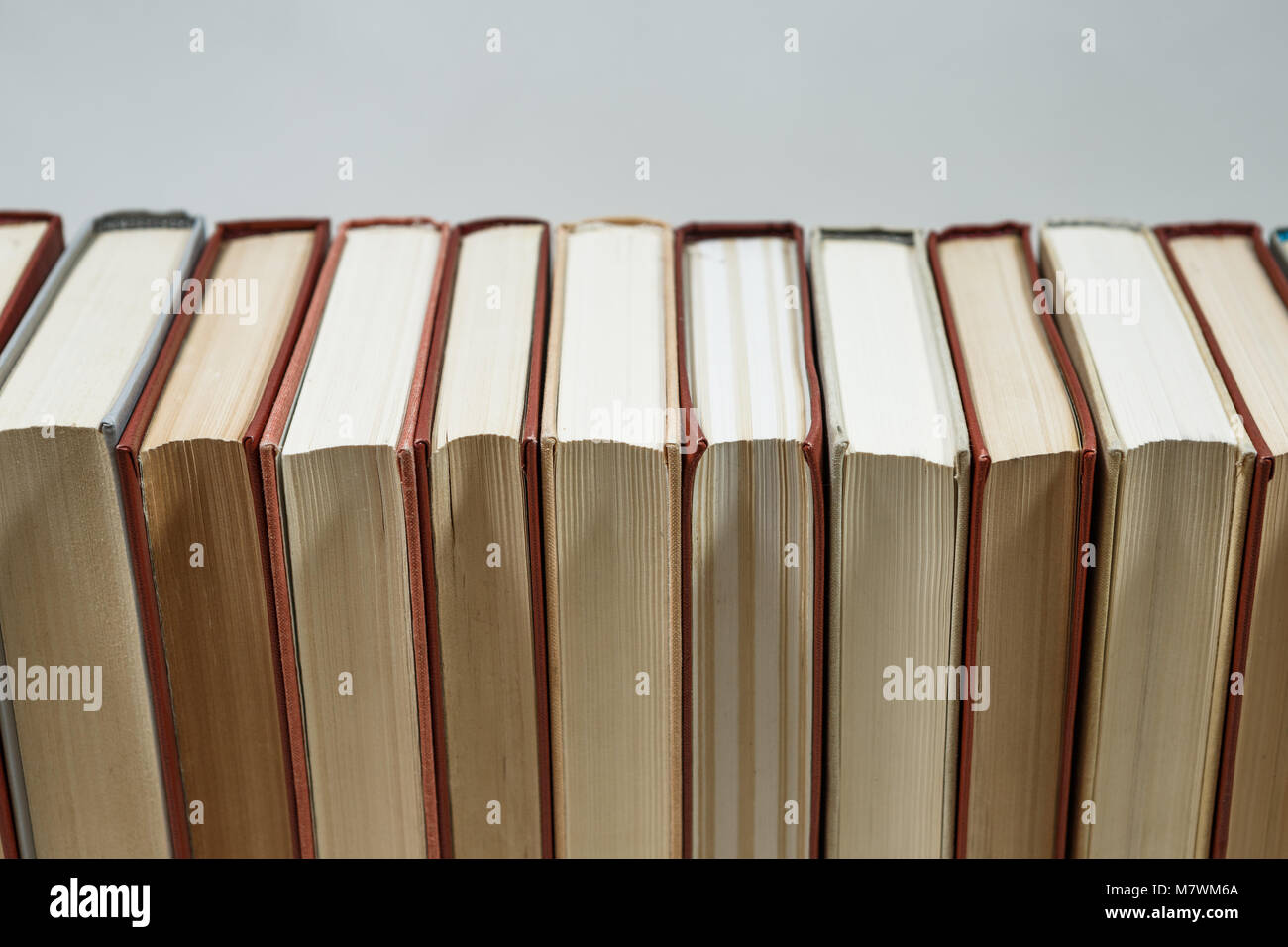 Pile of old pastel colors books stacked Stock Photo - Alamy