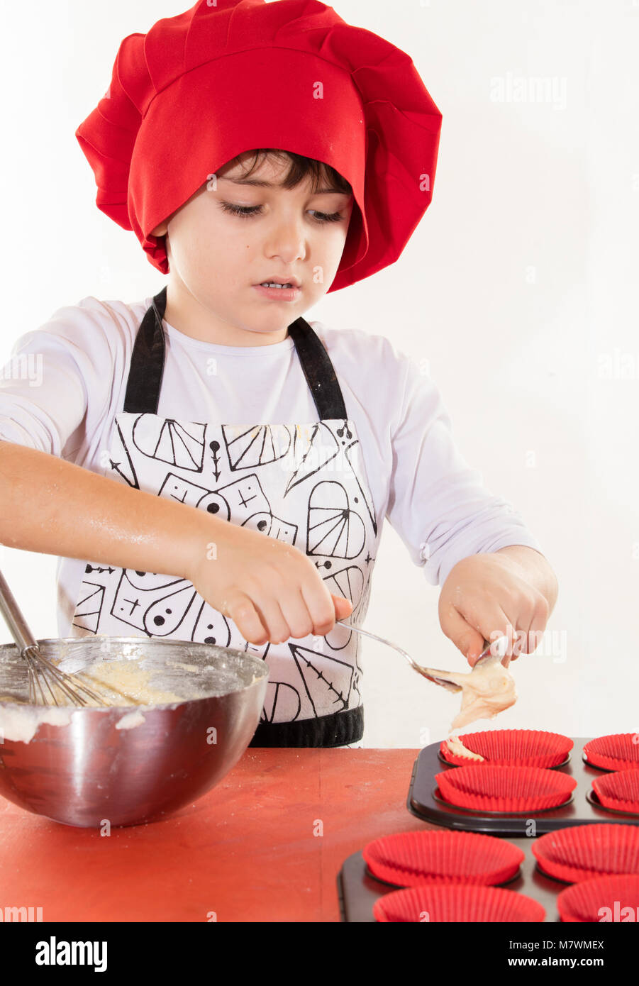 cute little clothes chef boy preparing cupcakes Stock Photo - Alamy