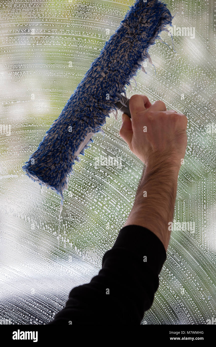 a soapy window with a squeegee cleaning the glass Stock Photo - Alamy