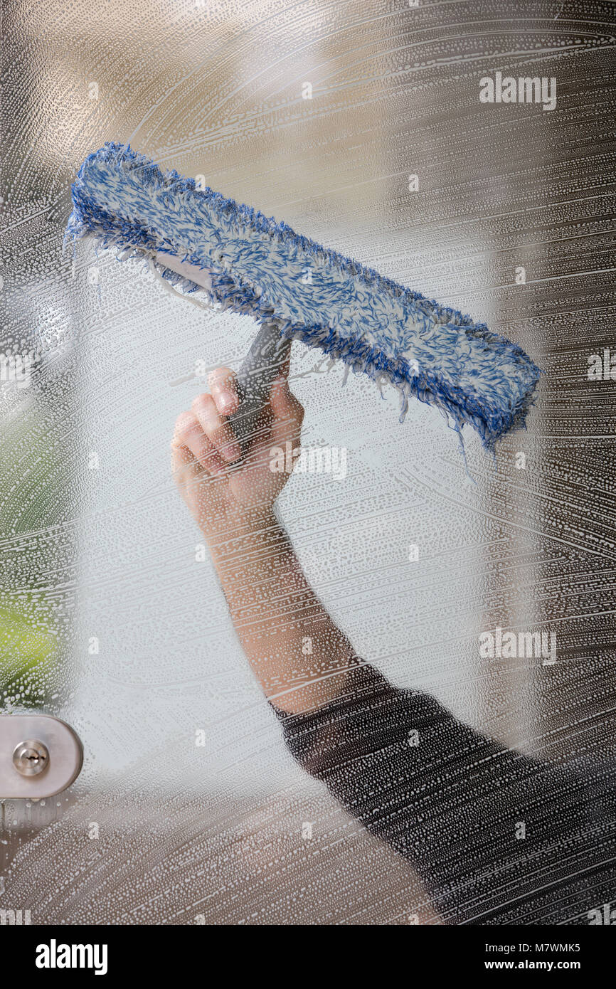 a soapy window with a squeegee cleaning the glass Stock Photo - Alamy