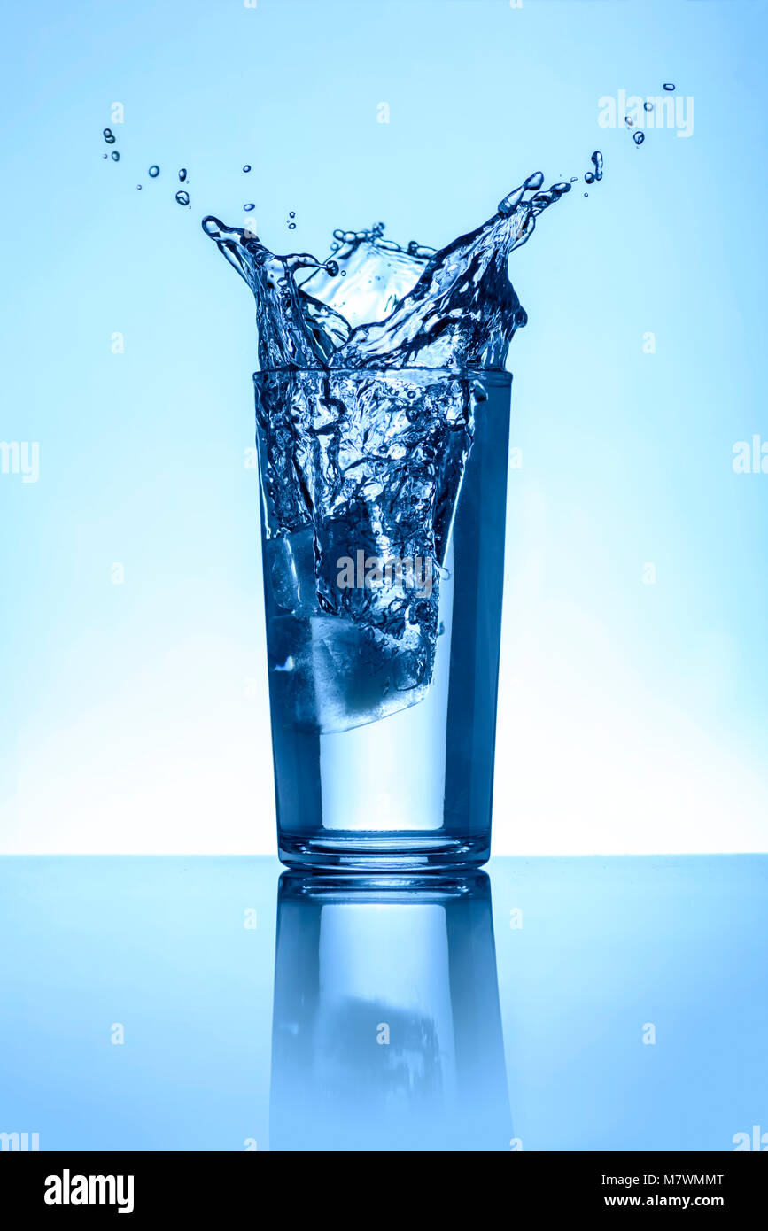 Natural Water Splash in A Glass Over Light Blue Background Stock Photo ...