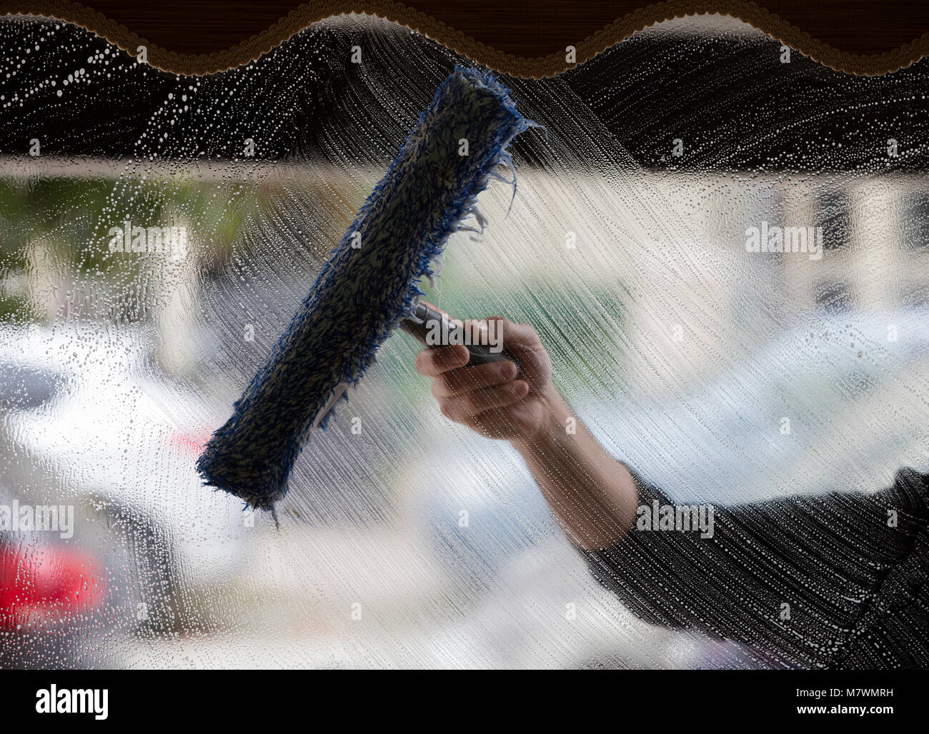 a soapy window with a squeegee cleaning the glass Stock Photo - Alamy