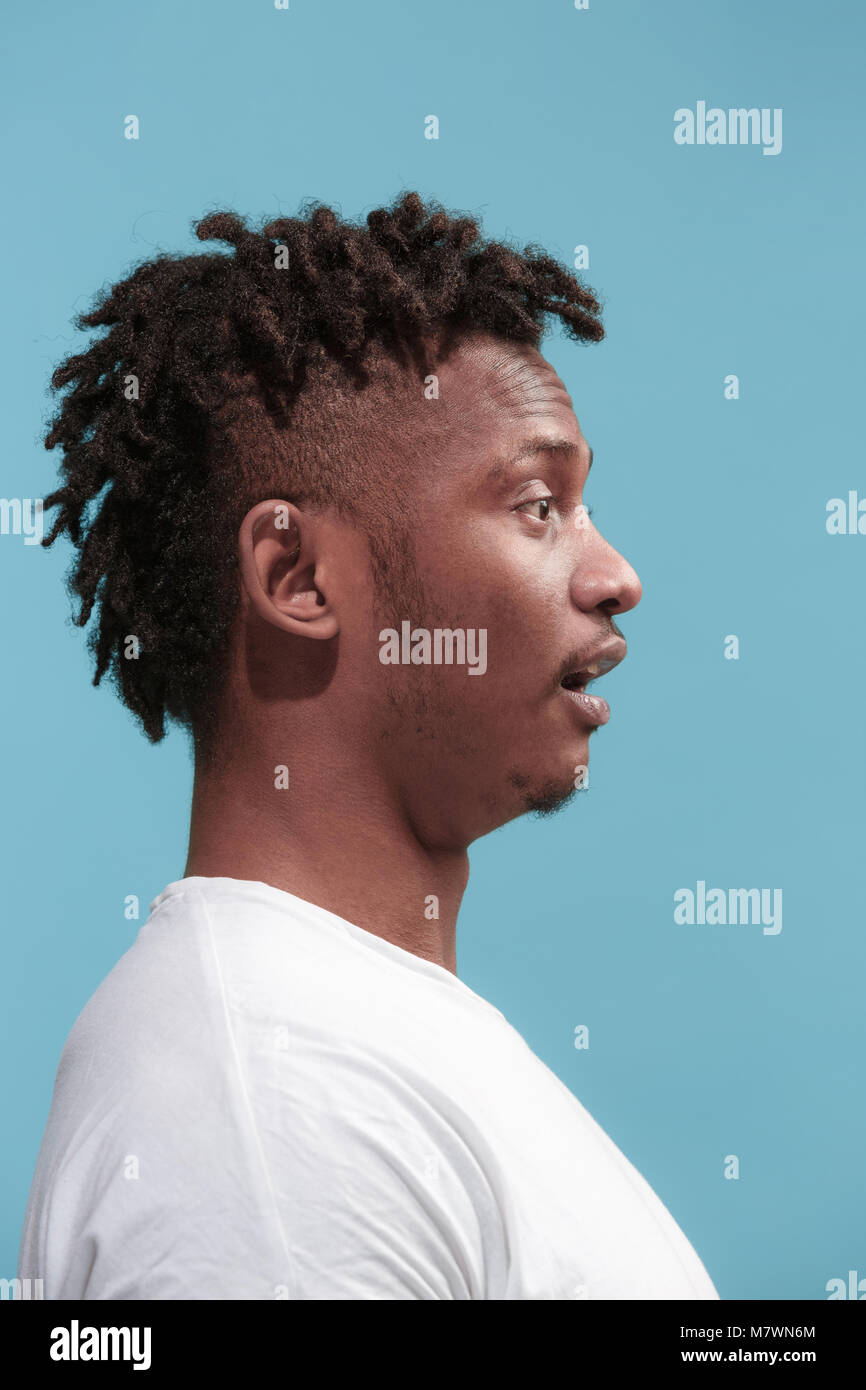 The surprised business Afro-American man standing and looking blue ...