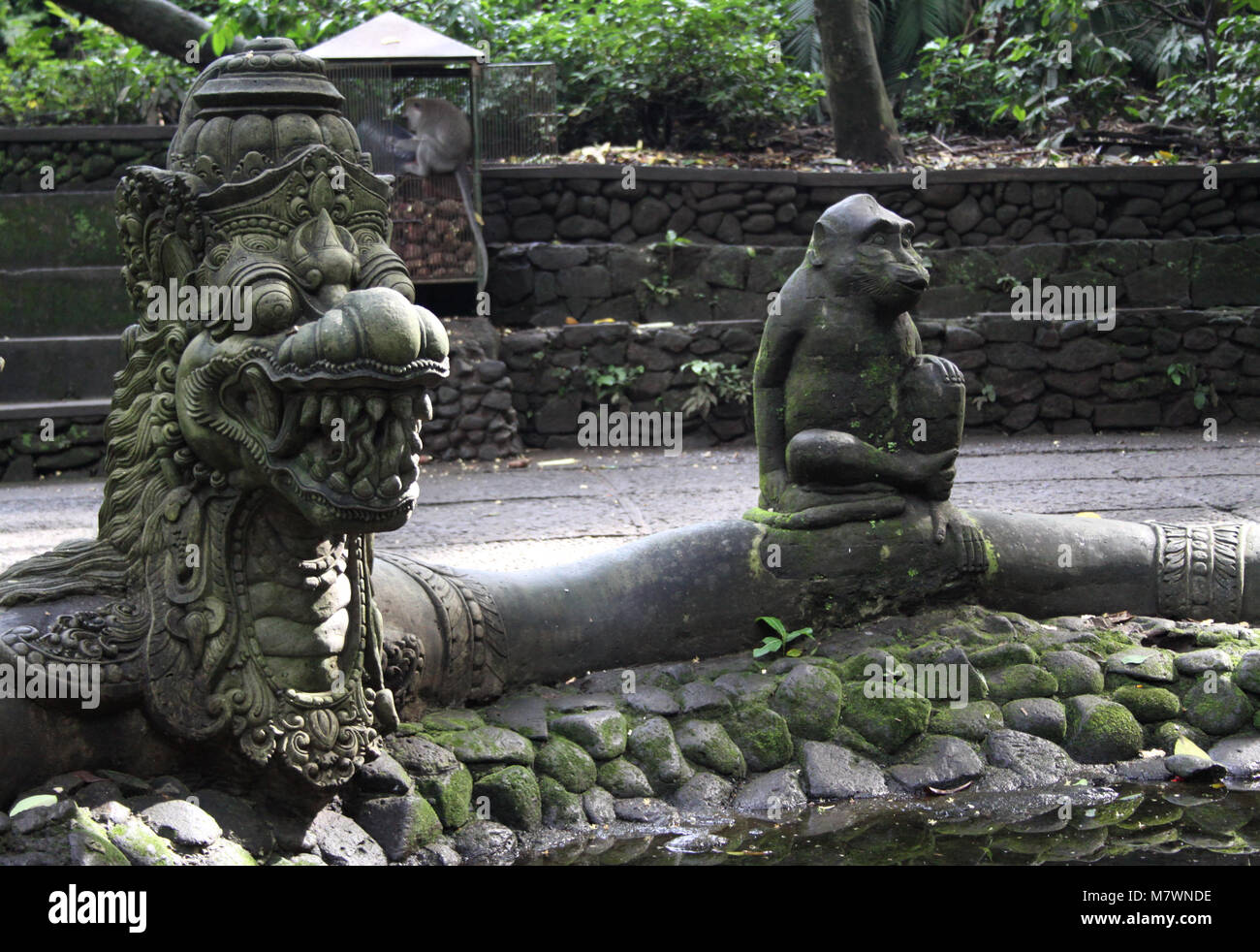 Dragon statue with a monkey Stock Photo - Alamy