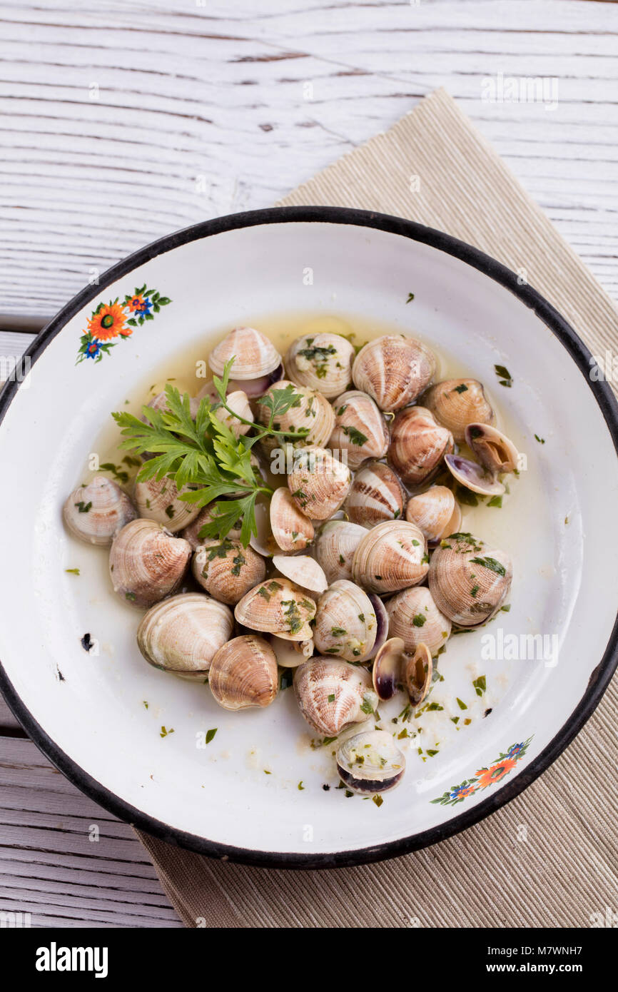 clams in very old plate with green parsley Stock Photo - Alamy