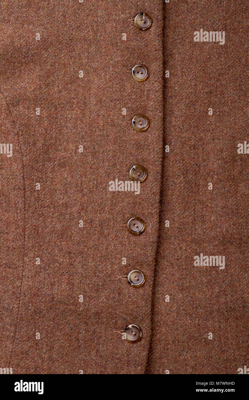 Buttons on brown woolen clothes. Close up column of buttons, vertical ...