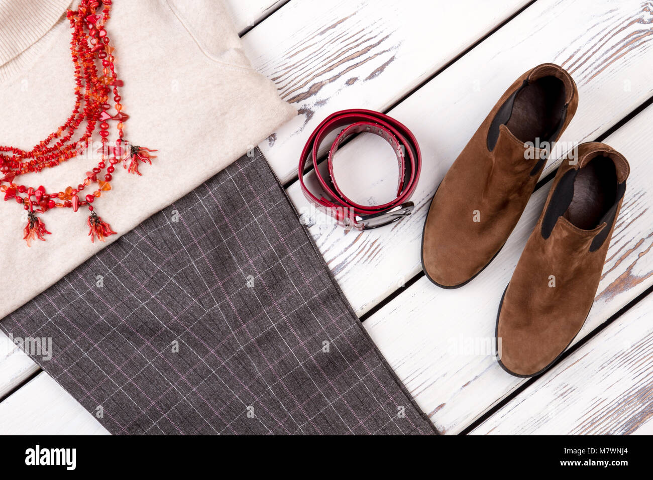 Close up winter women's clothes and accessories. Brown suede shoes ...