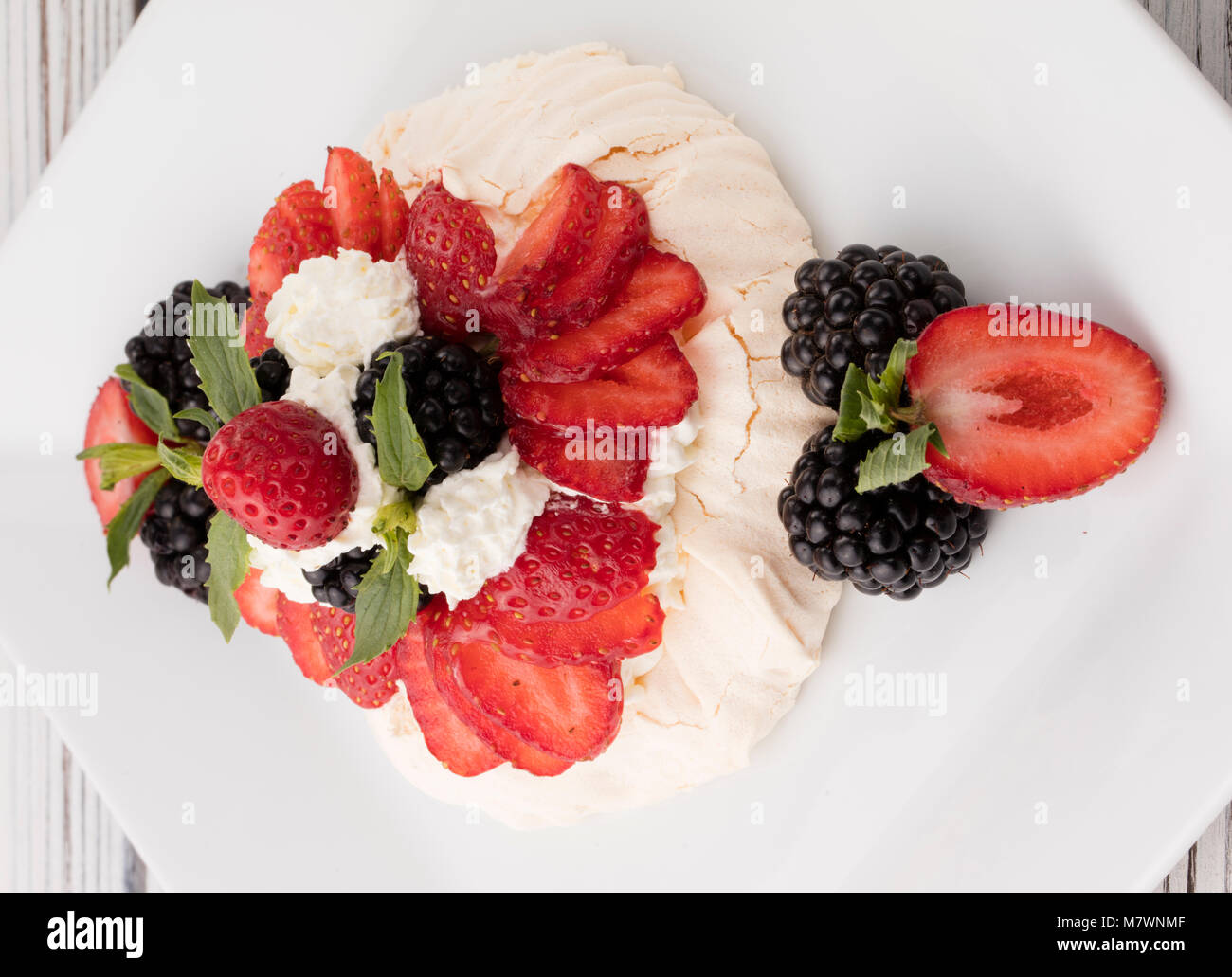 pavlova desert with cherry on white background Stock Photo - Alamy