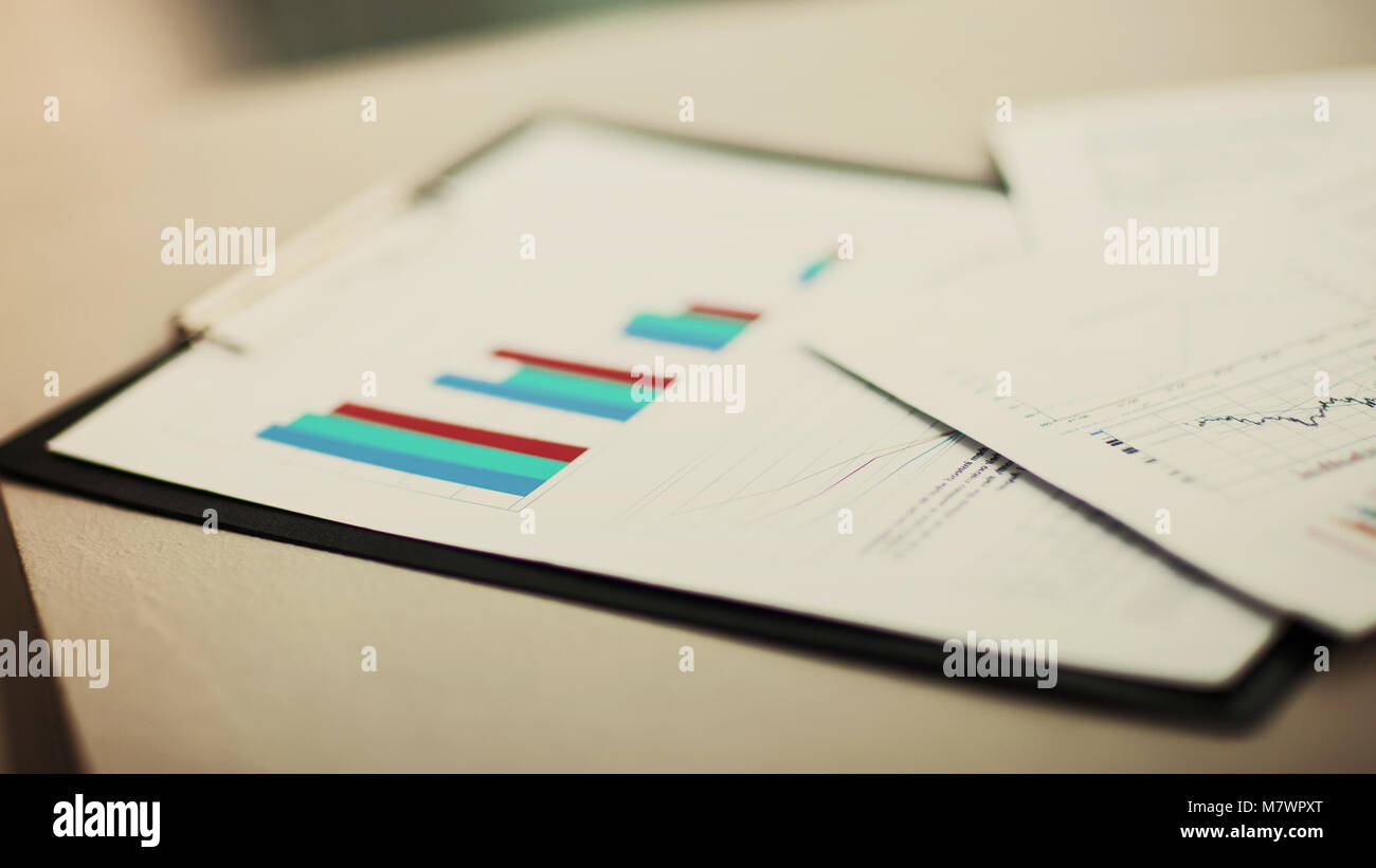 financial charts and graphs on the table in a modern office Stock Photo ...