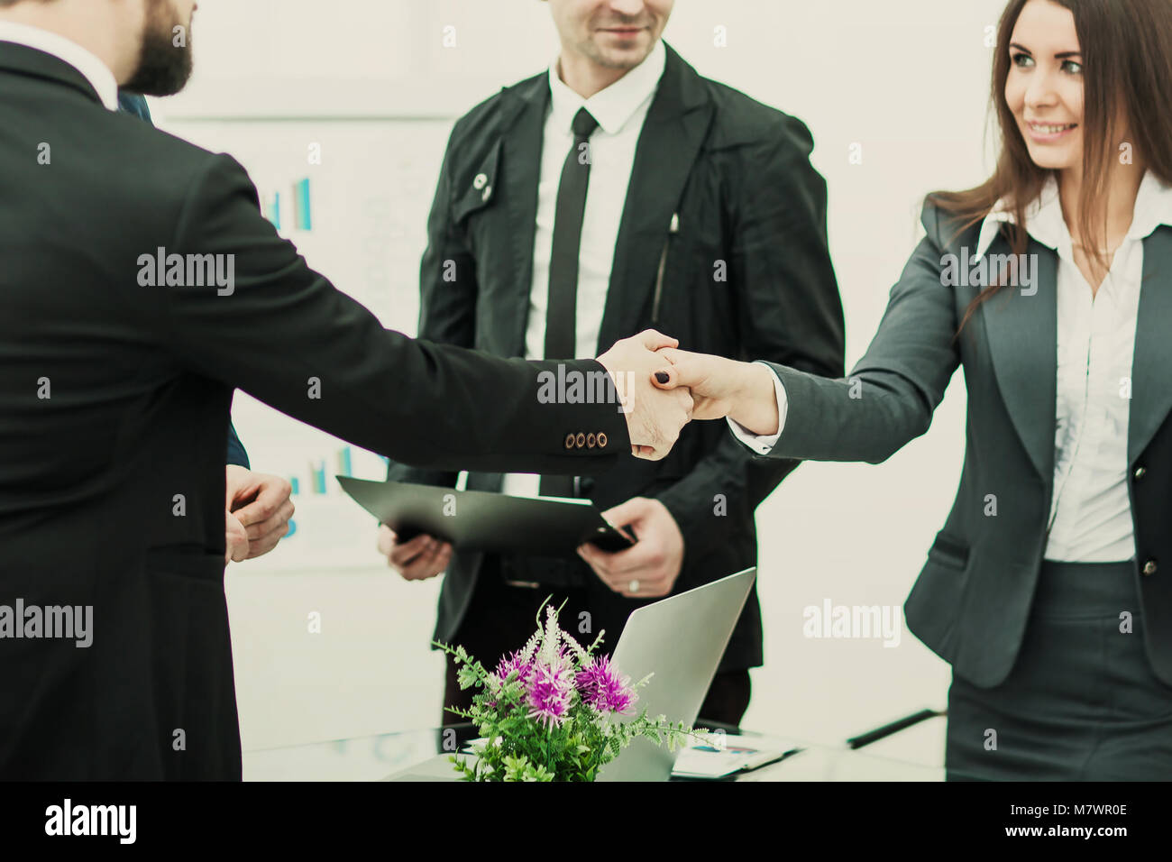 closeup of a successful handshake business partners after signing the ...