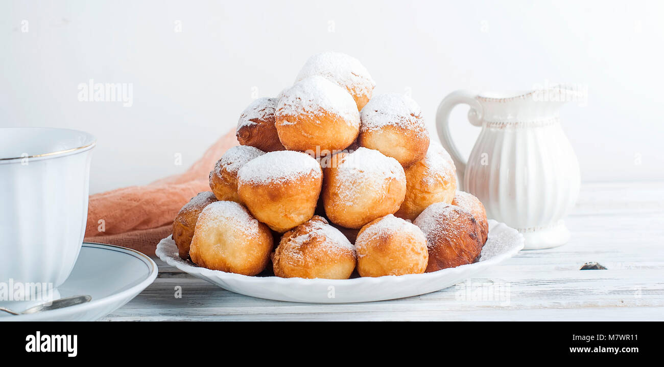 sweet donuts laid out pyramid sprinkled with powdered sugar on the ...