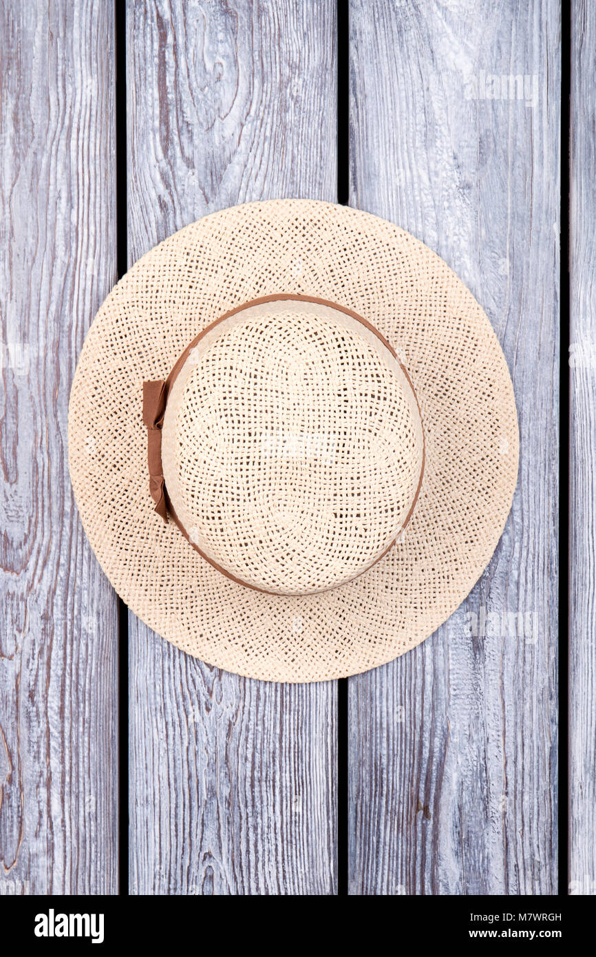 Straw brim summer hat, flat lay. Grey desk surface background Stock ...