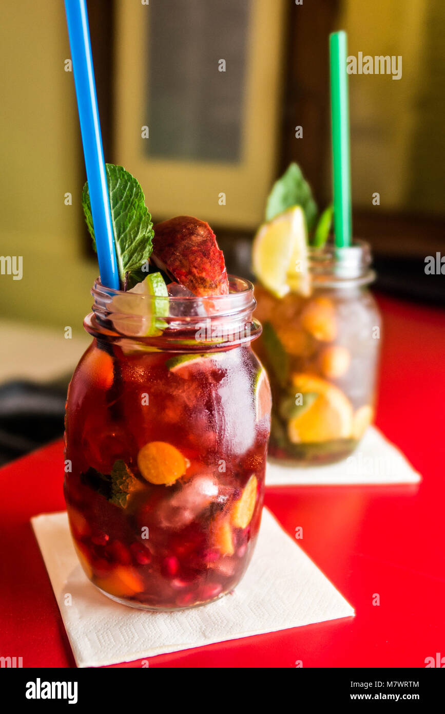 Homemade lemonade ice tea colorful icetea drink with fresh sweet fruits ...