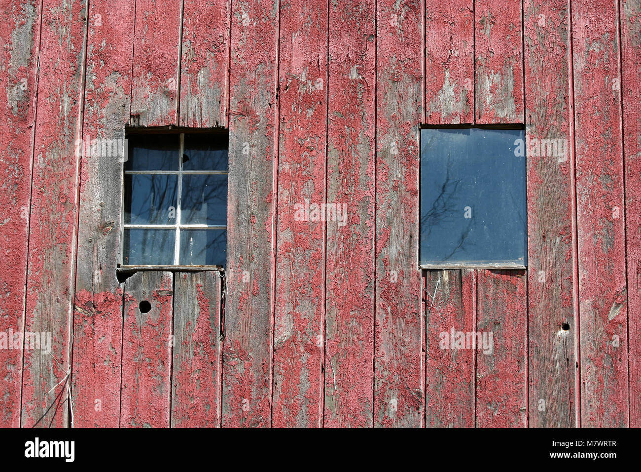 Two window on the side of a old barn image Stock Photo - Alamy