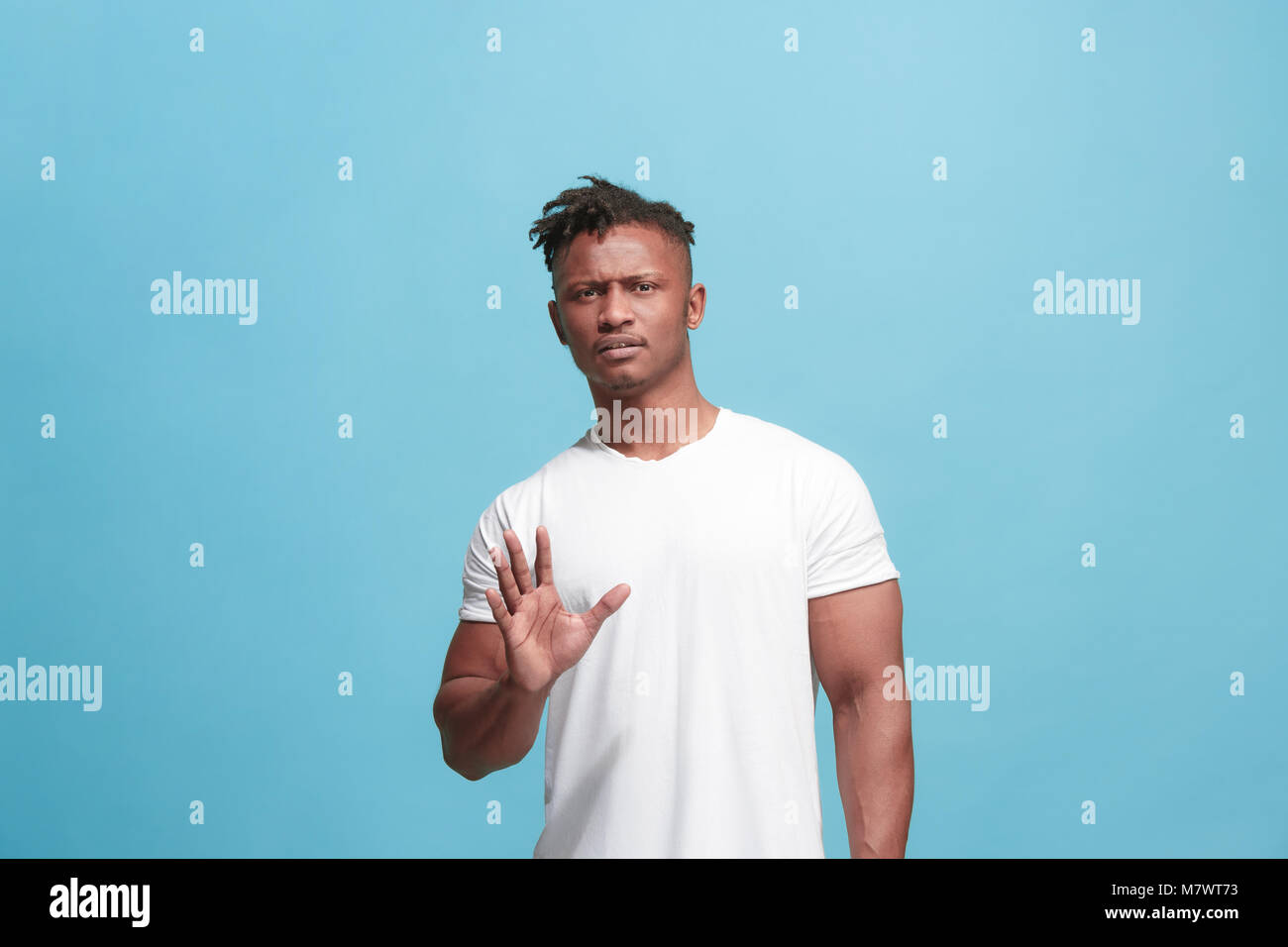 Young man with disgusted expression repulsing something, isolated on ...