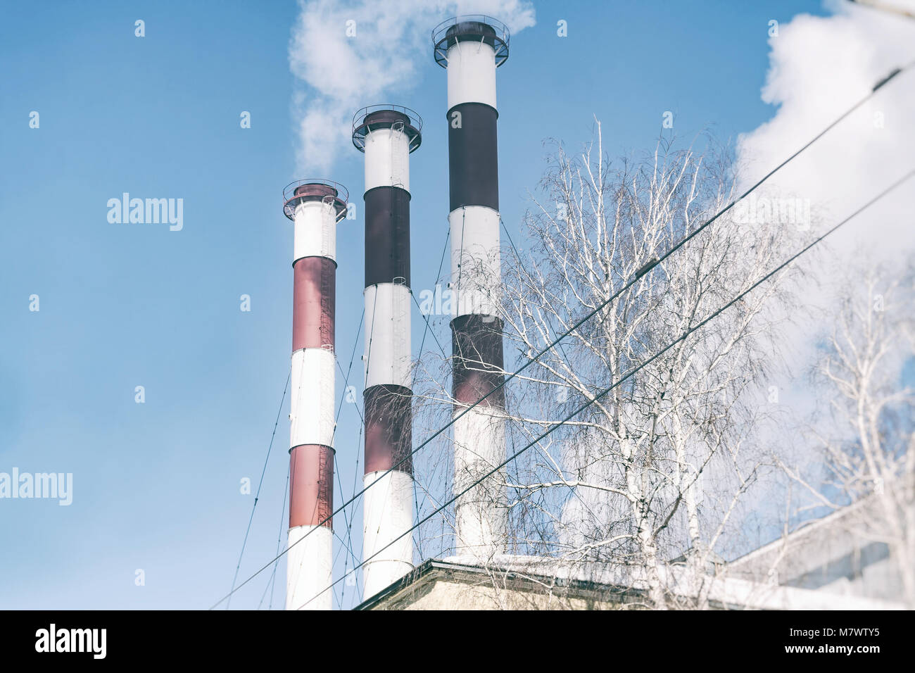 Three factory pipes smoke Stock Photo - Alamy